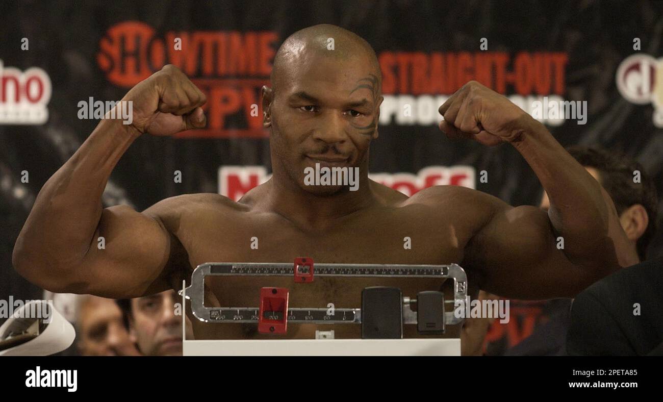 Former heavyweight champion Mike Tyson flexes his muscles for ...