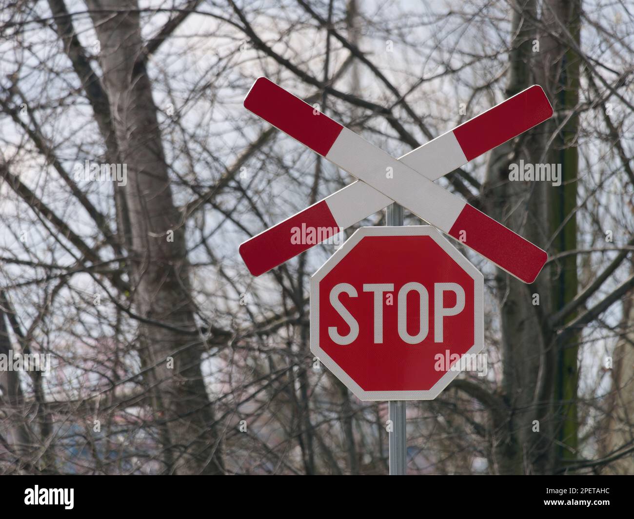 An isolated stop sign featuring a pair of railroad crossing symbols on ...