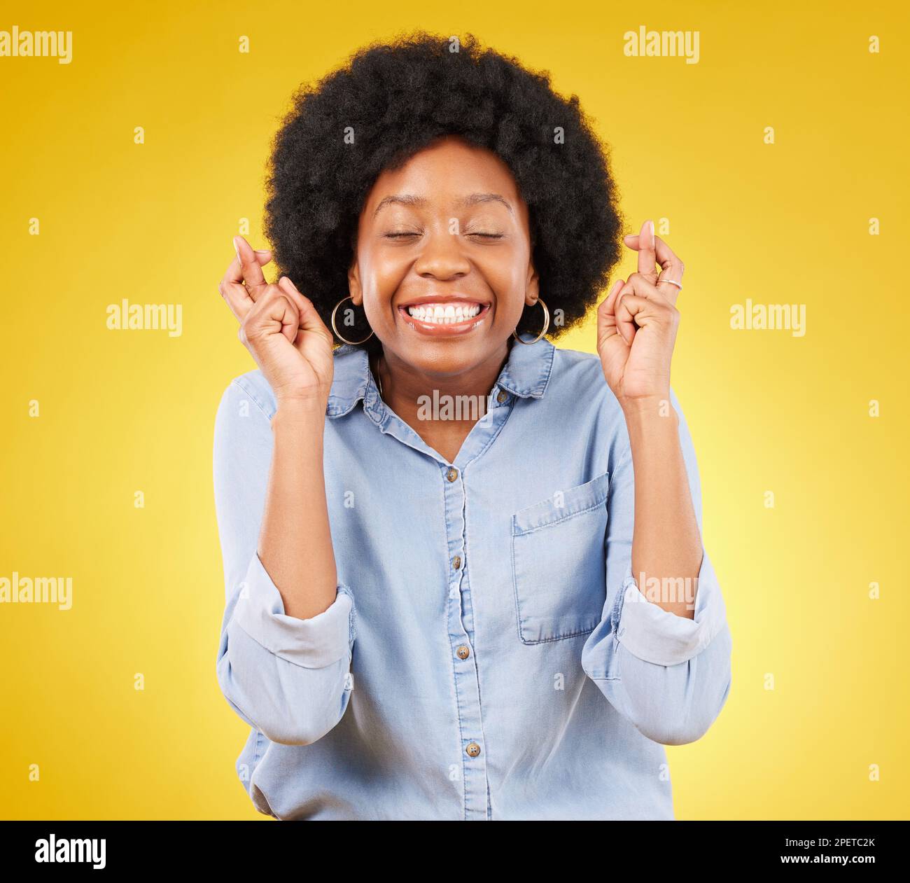 Happy, smile and fingers crossed by black woman in studio for wish ...