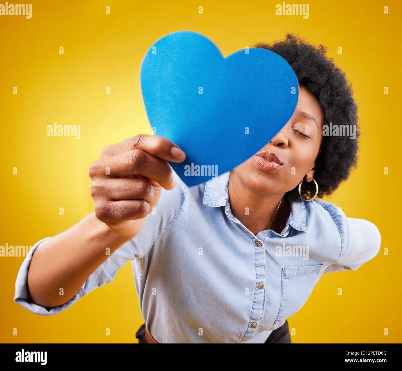 Paper, heart and kissing with black woman in studio for romance ...