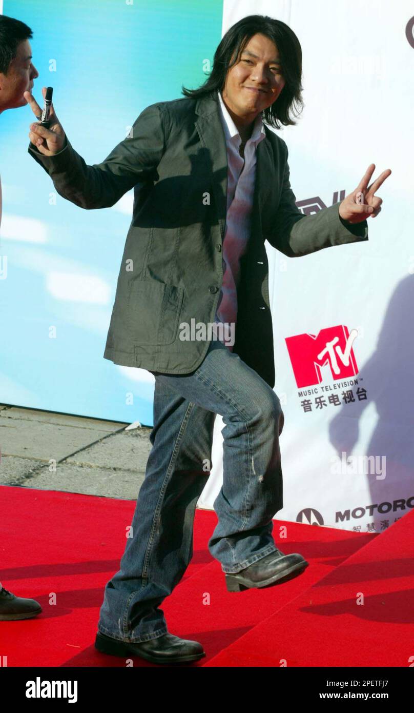 Singaporean singer, Ah Du poses as he walks past reporters to attend ...