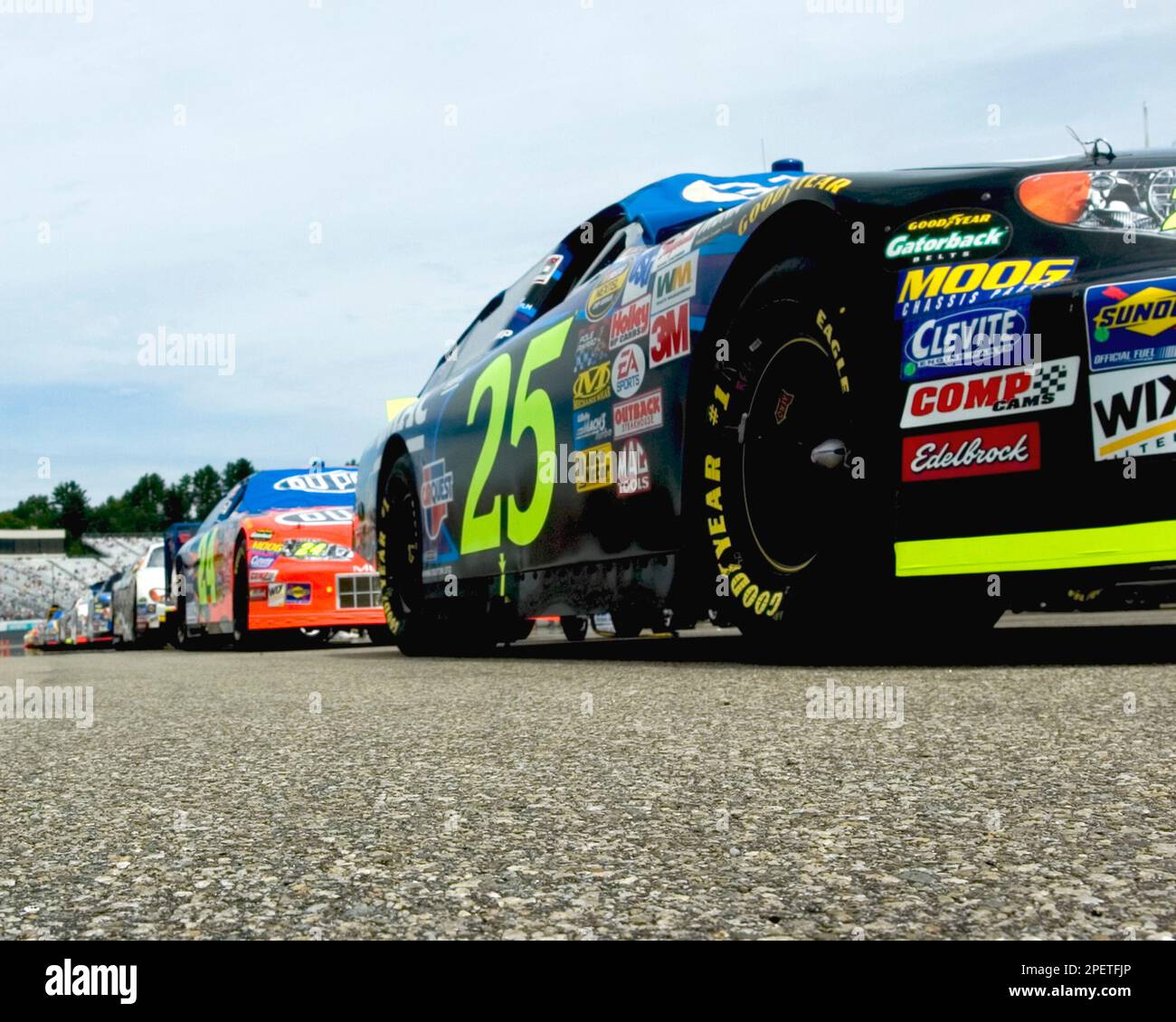 NASCAR Nextel Cup race cars sit idle along pit row before the start of ...