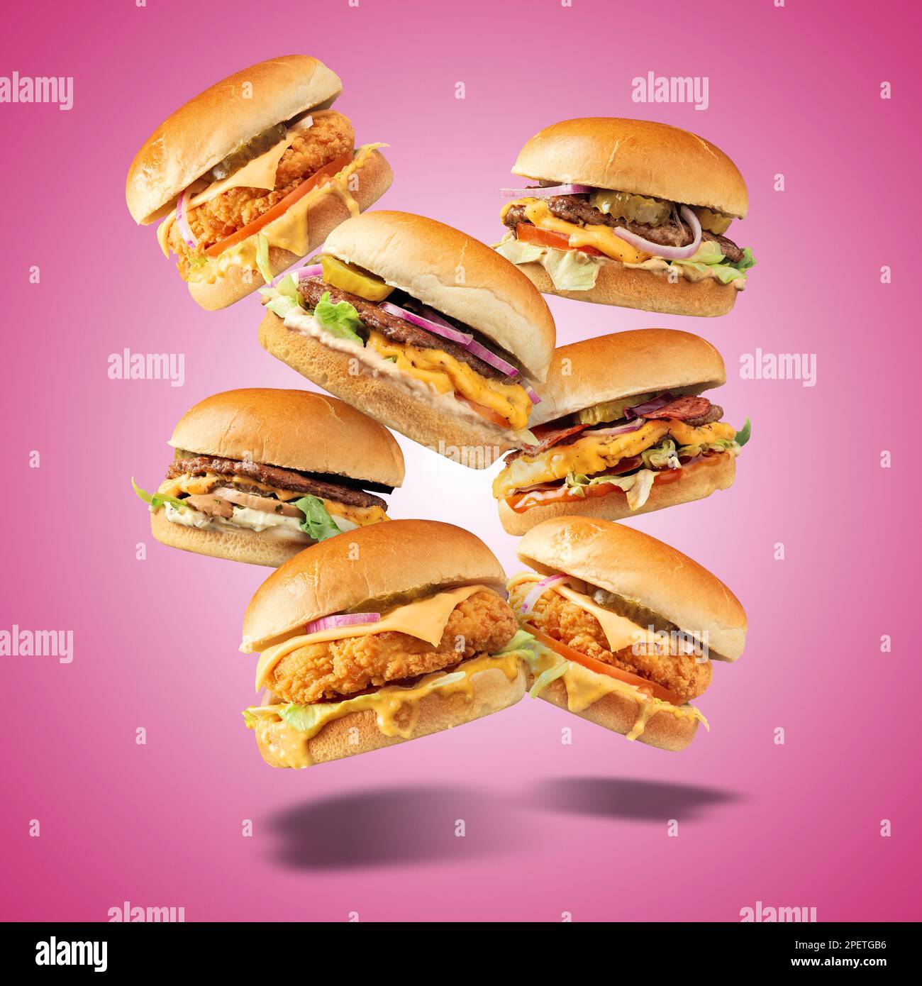 Floating Collection of seven Burgers on rose gradient background Stock ...