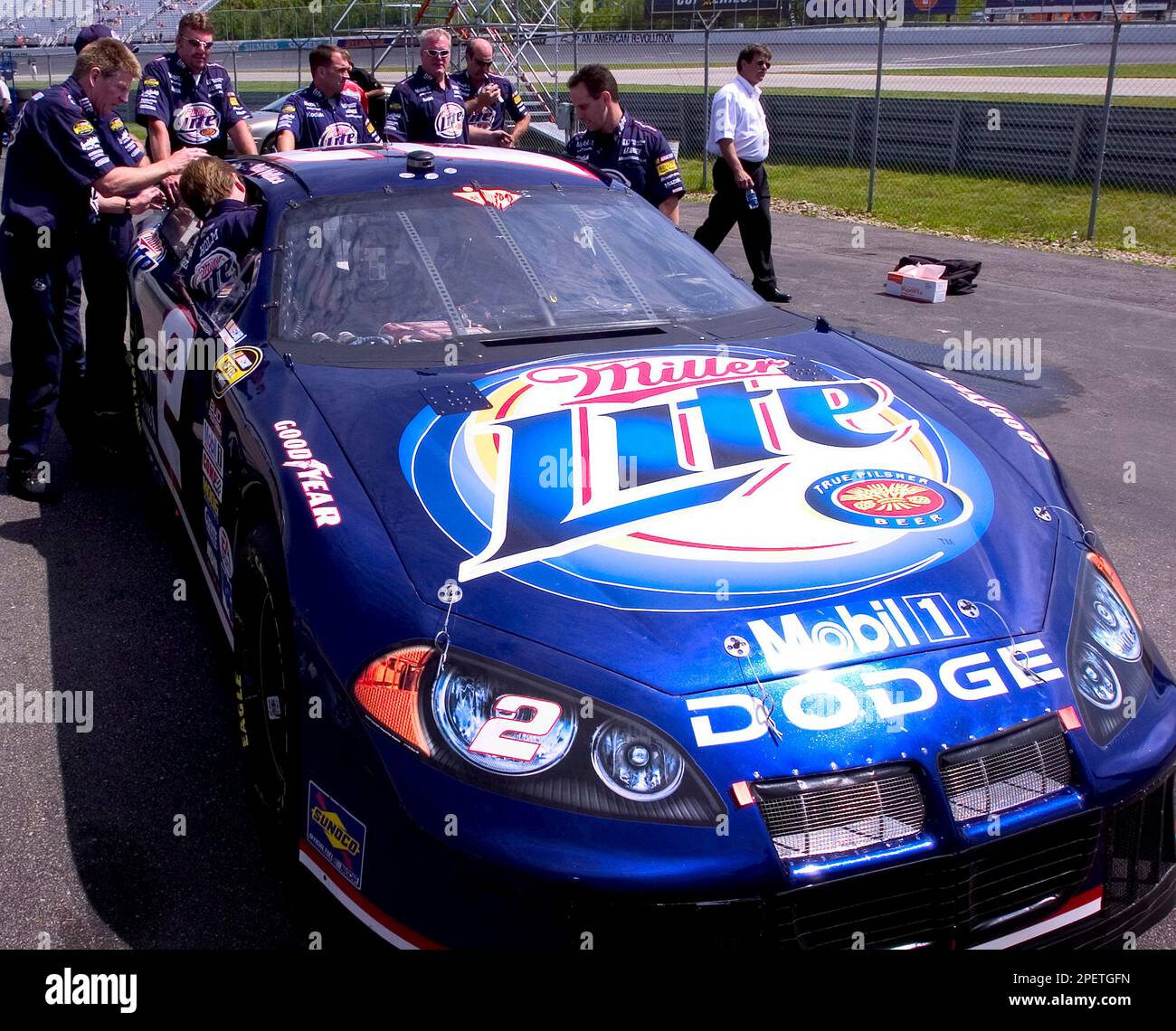 Crew members of the NASCAR Nextel Cup Miller Lite Dodge team make a ...