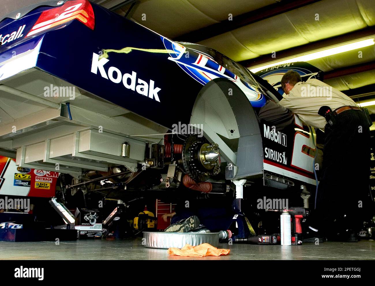 Crew members of the NASCAR Nextel Cup Miller Lite team work on the race ...