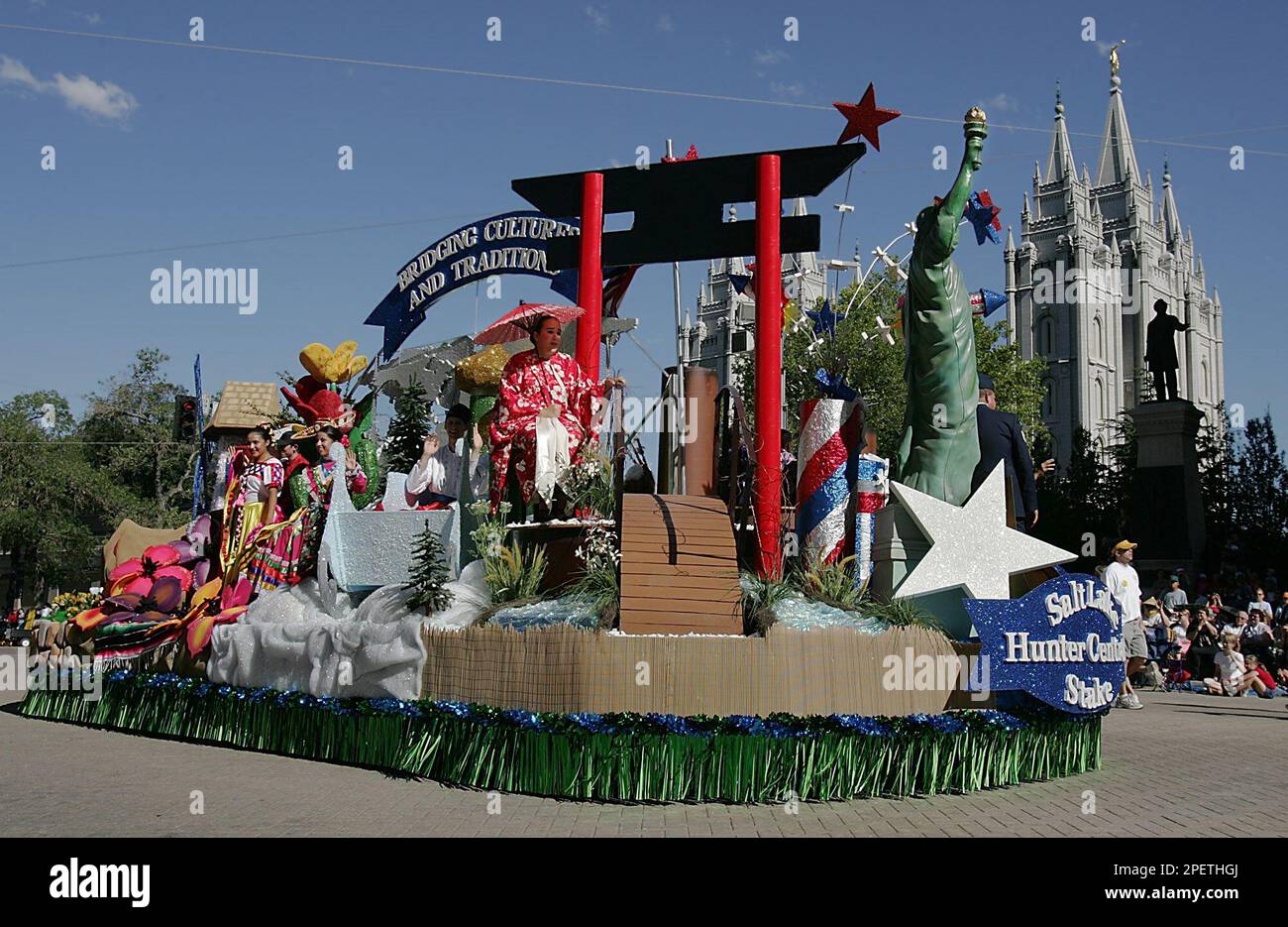 The theme award winning float passes the Mormon temple, rear, during ...