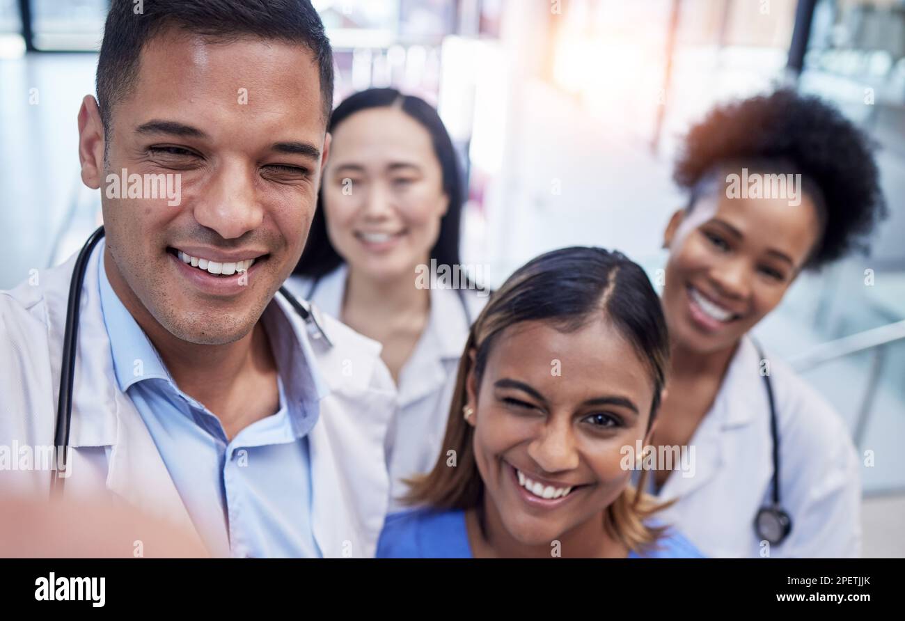 Wink, portrait and group selfie of doctors in hospital with pride, smile and clinic teamwork ...