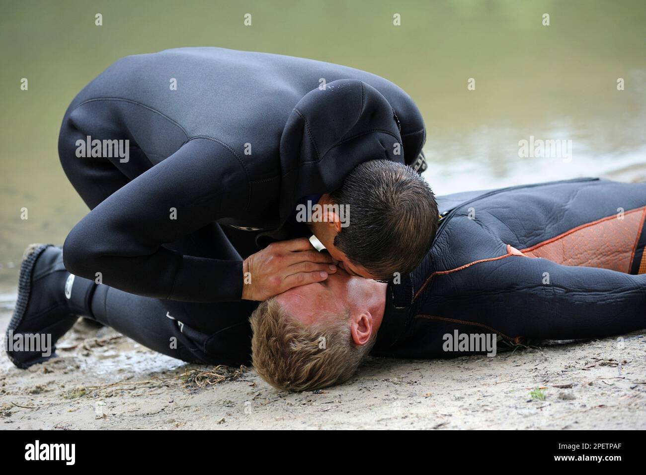 Lesson of artificial respiration. Lifeguard giving drowning mouth-to ...