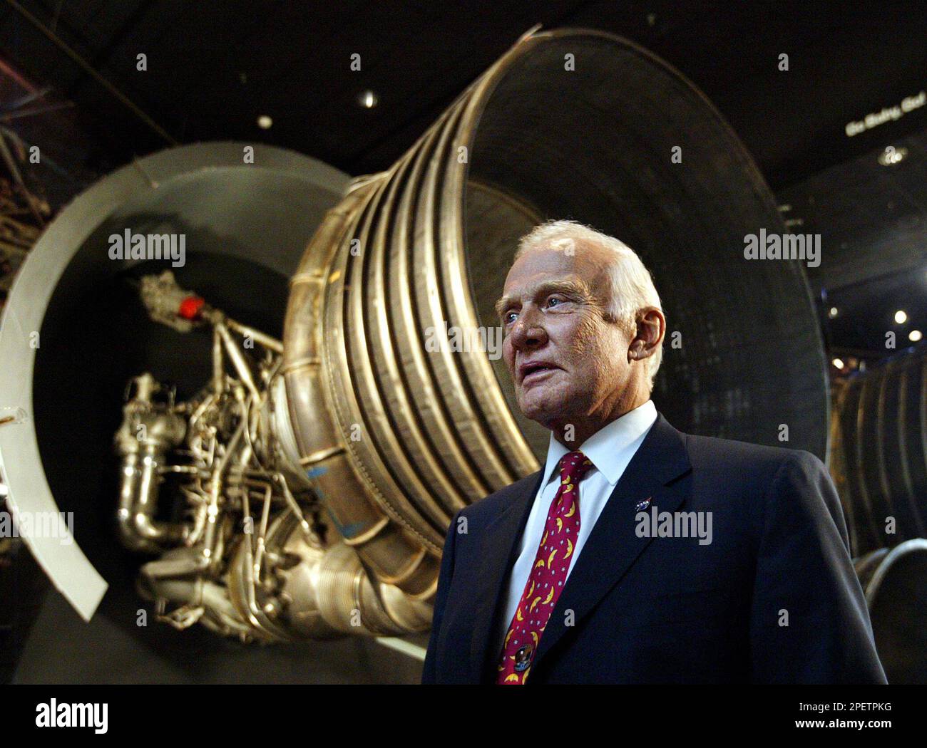 Apollo 11 astronaut Buzz Aldrin, speaks to a reporter in front of the Saturn 5 Aft End, the F-1 ...