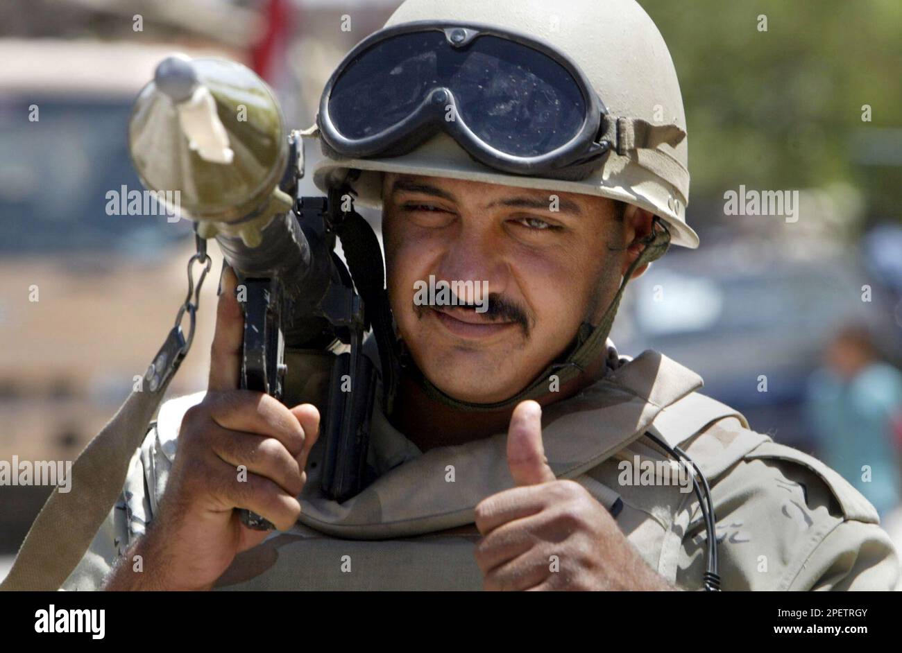 An Iraqi Army 2nd Battalion soldier carries a rocket-propelled grenade ...