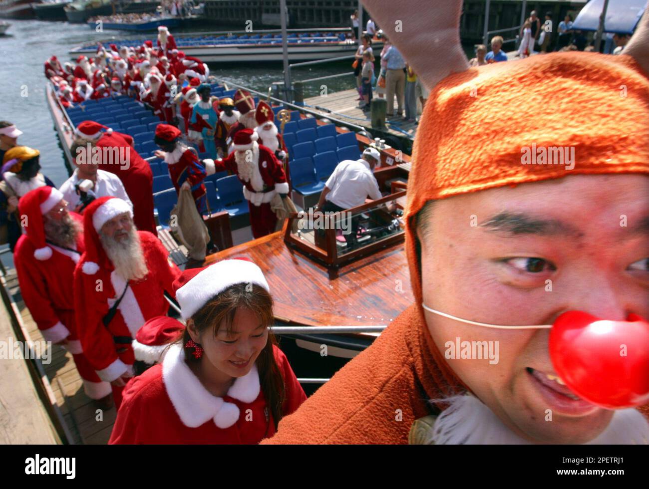 Santas and their helpers, including Yutaka Iwabuchi of Japan dressed as ...
