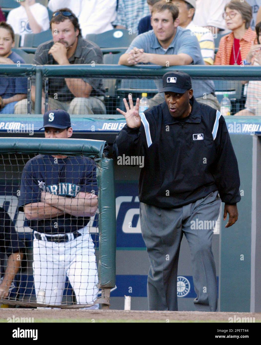 Umpire Chuck Mariwether walks out of the dugout signaling ball four for ...
