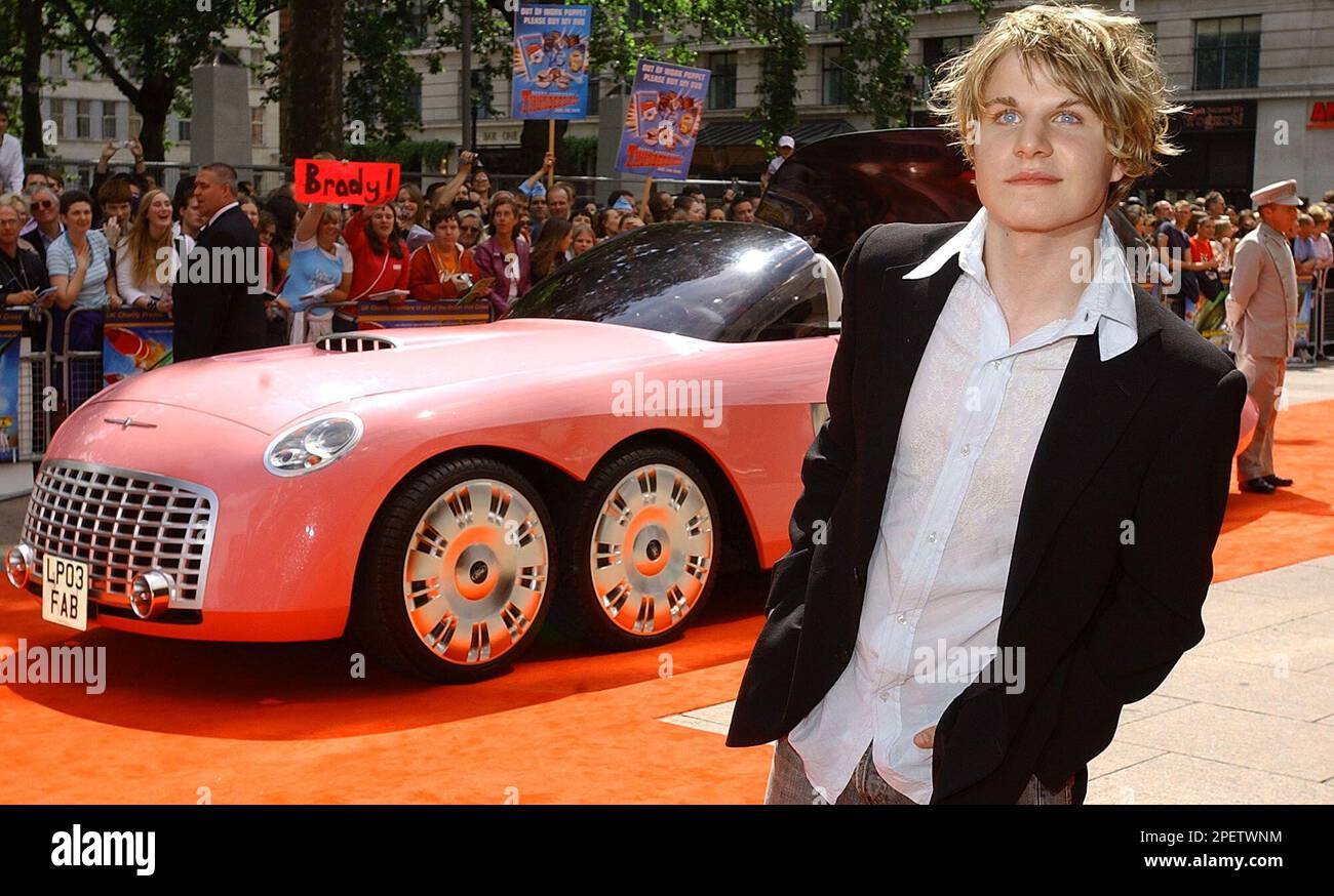 Brady Corbet, who plays Alan Tracy, poses by the Thunderbirds car at ...