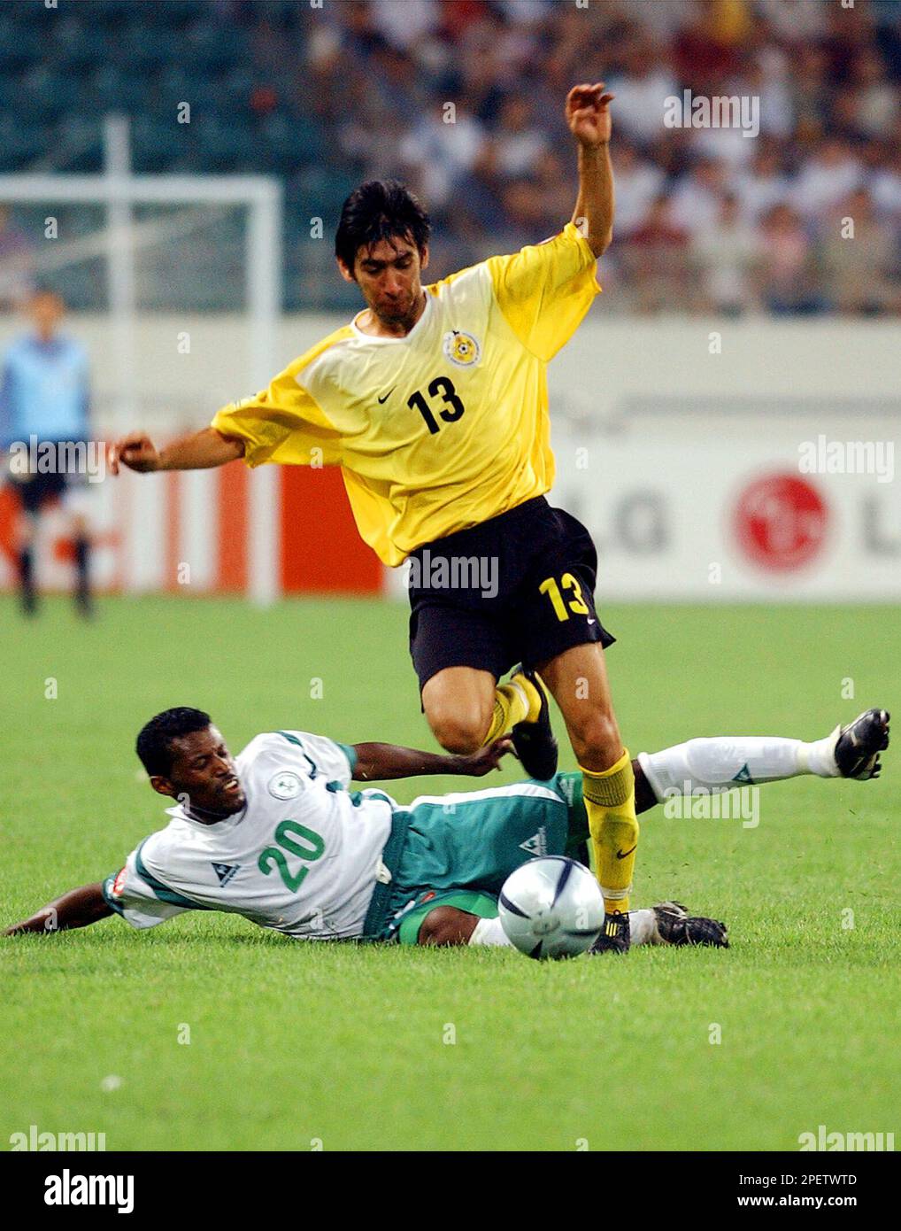 Saudi Arabia 's Abdulaziz Al Janoubi, bottom, competes for the ball ...