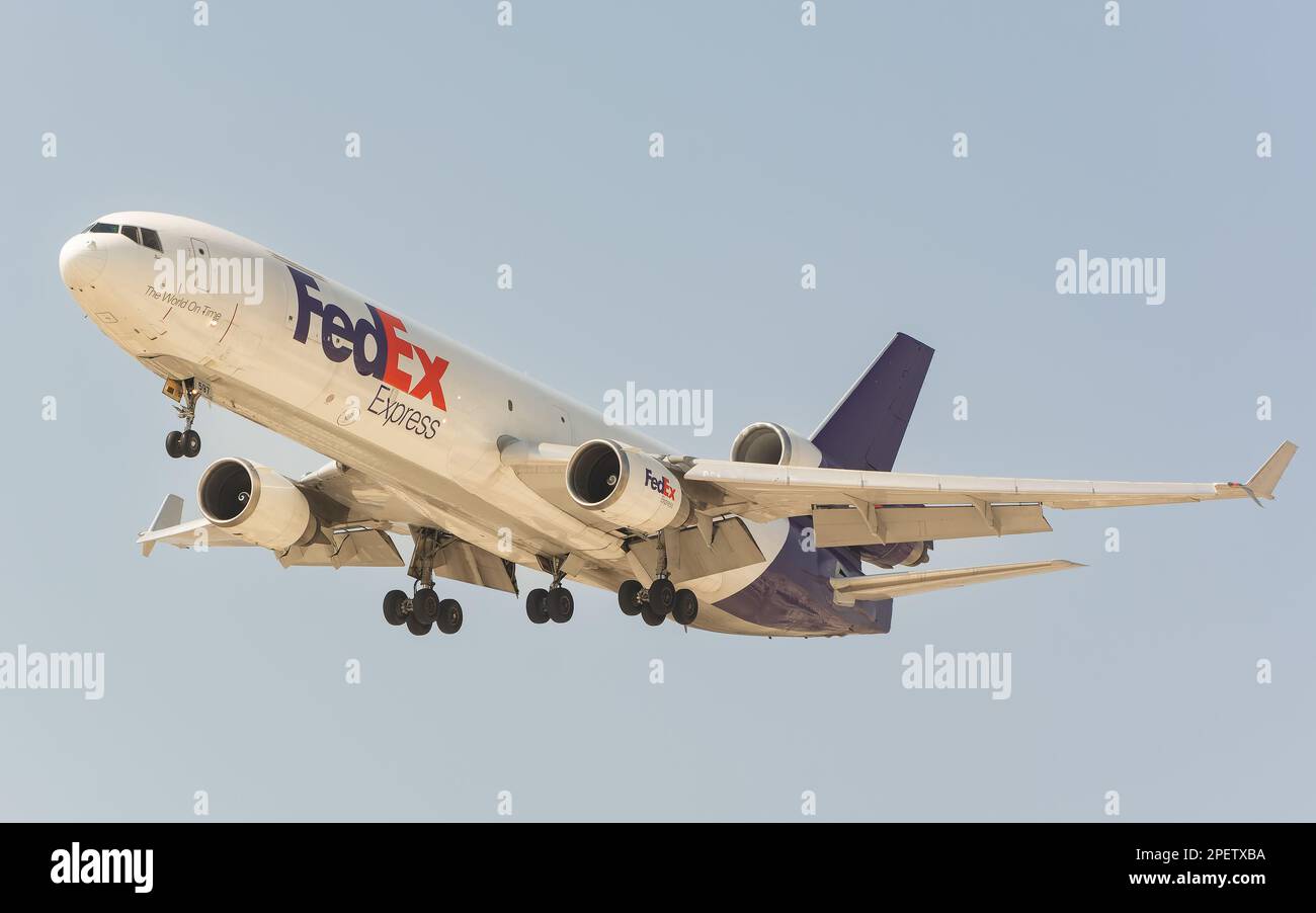 A low angle shot of a FedEx jet flying under the sunlight in Dubai, UAE ...