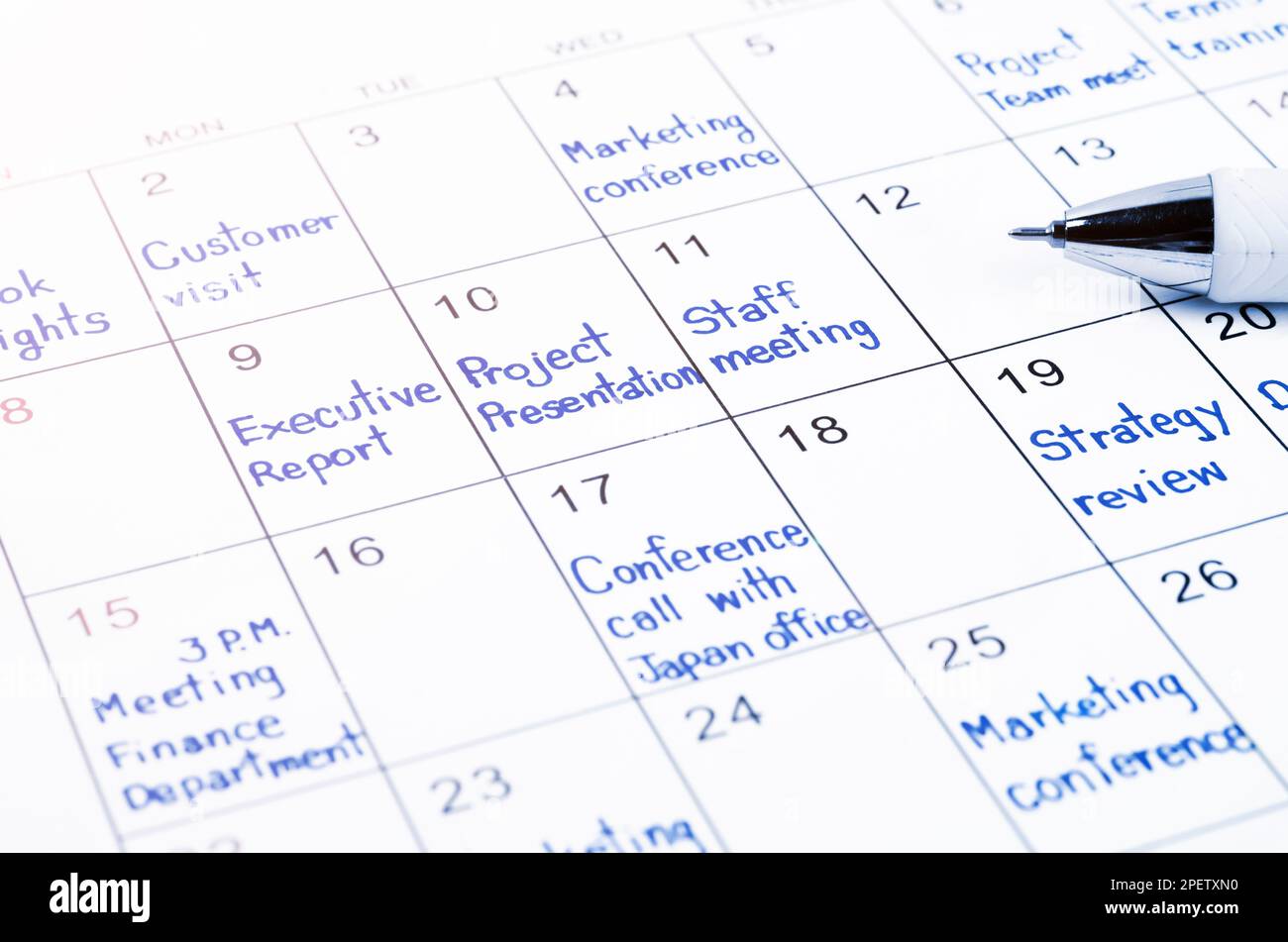 Handwriting scheduling appointments on calendar sheet with pen Stock ...