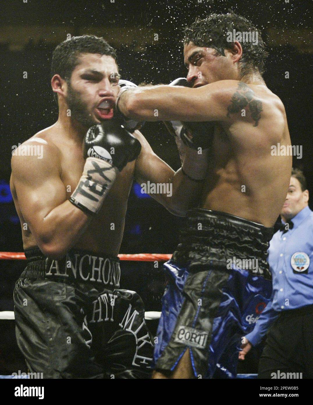 Julio Pablo Chacon of Argentina, right, slugs it out with Mike Anchondo ...