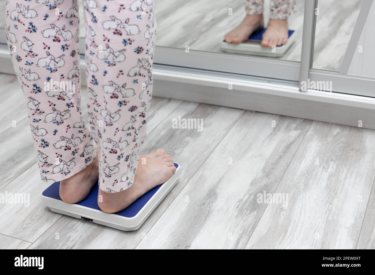 woman stepping on the scales to control her weight. weight loss and ...