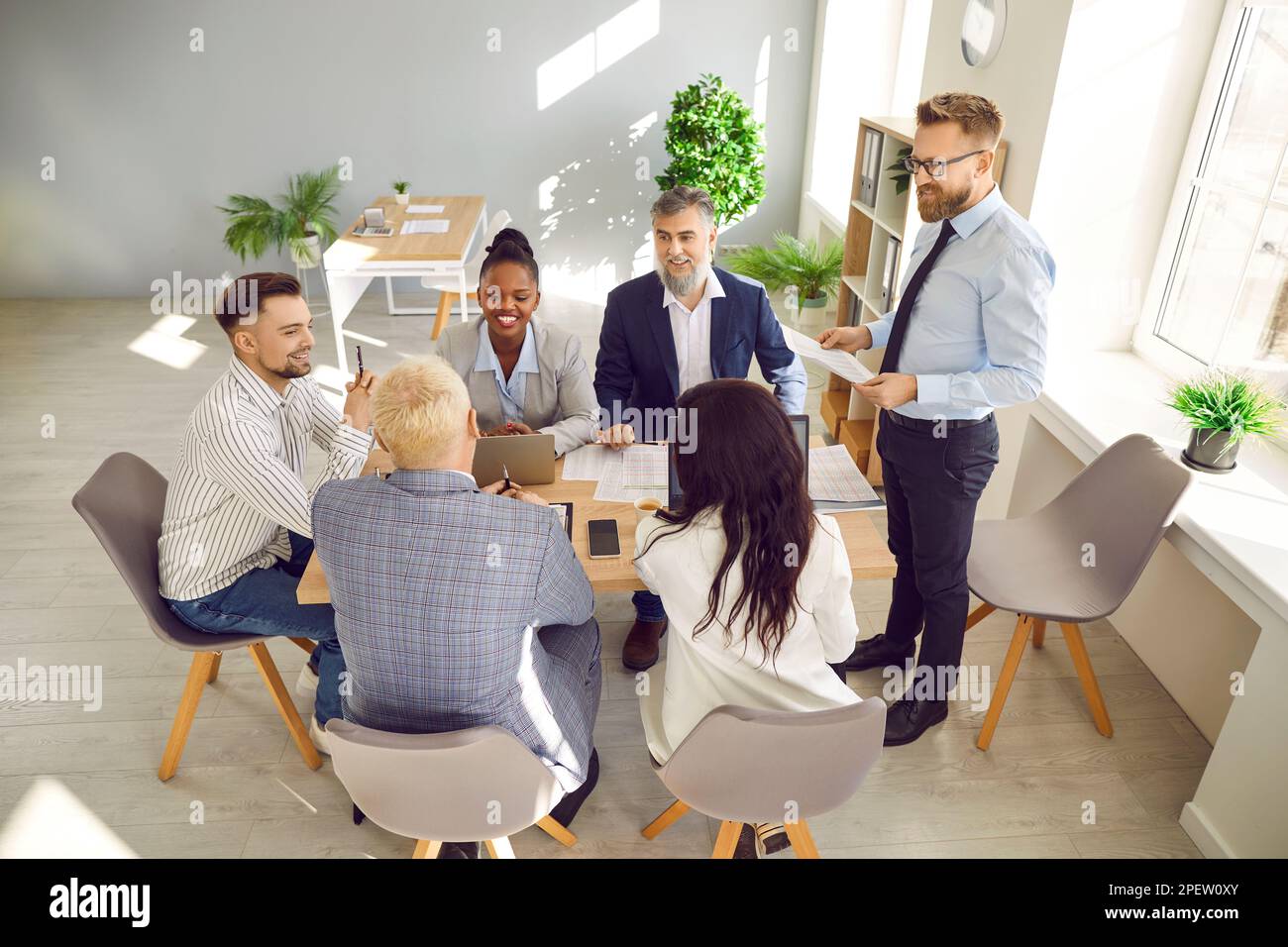 Happy multicultural business people discussing corporate project at ...