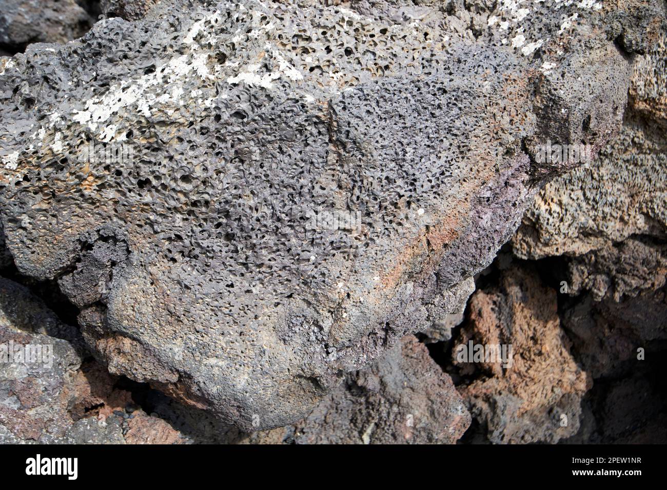 range of colours in volcanic rock on the edge of lava field parque ...