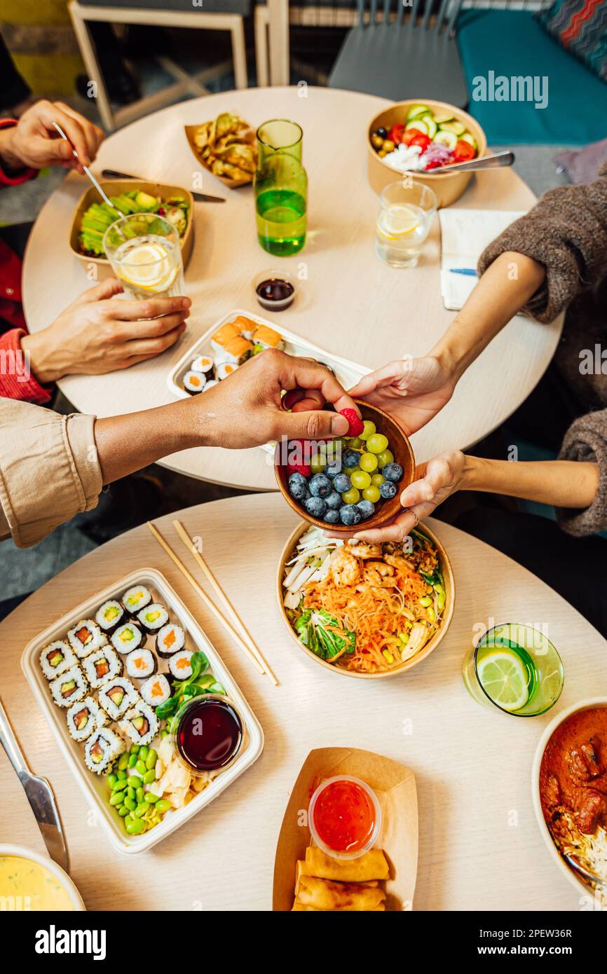 A group of people enjoying a meal together at a restaurant Stock Photo ...