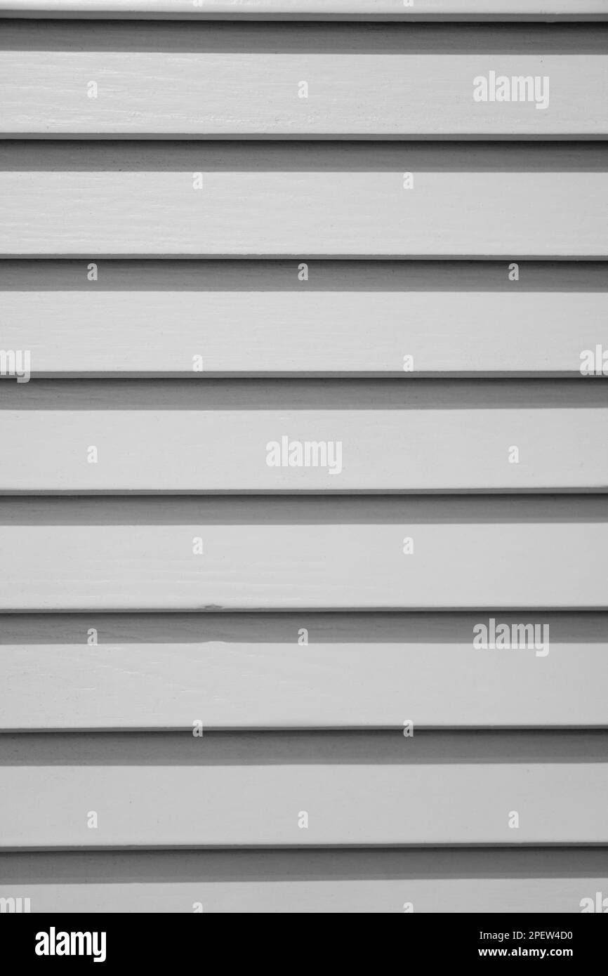 A vertical grayscale shot of an exterior wall with layers Stock Photo ...