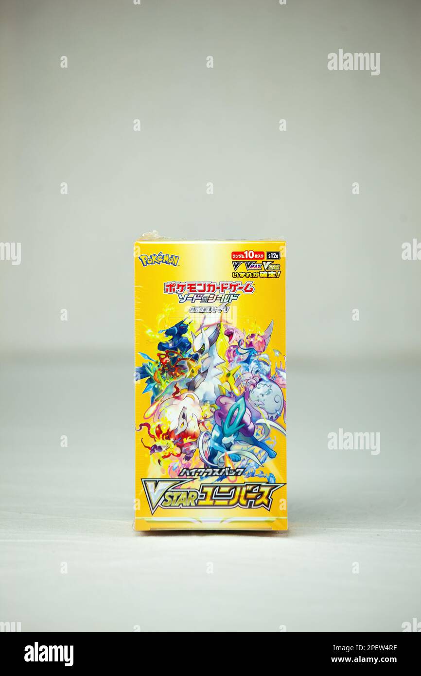 A vertical shot of a Pokemon one piece card game box against a grey ...