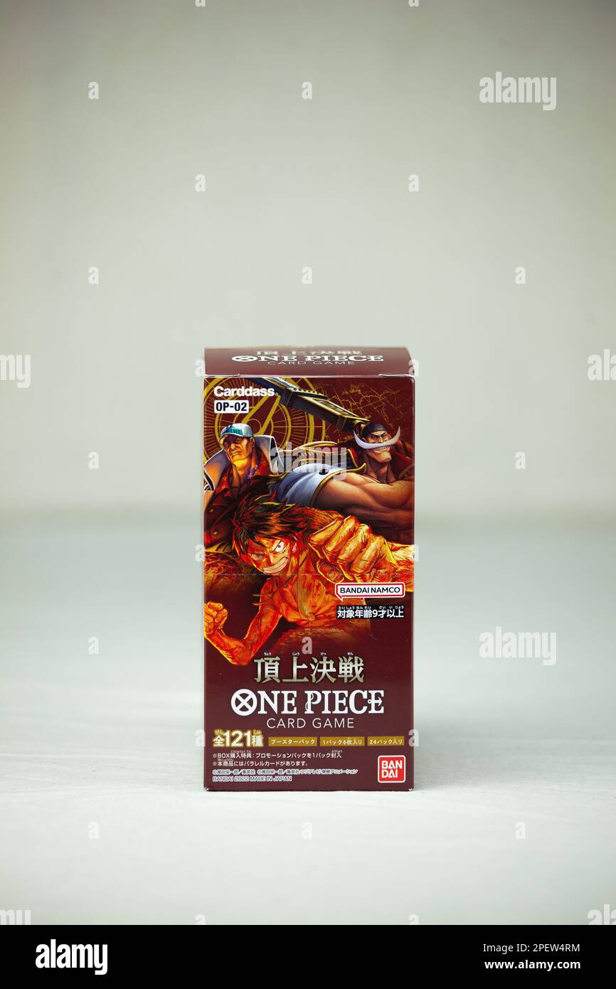 A vertical shot of a Pokemon one piece card game box against a grey ...
