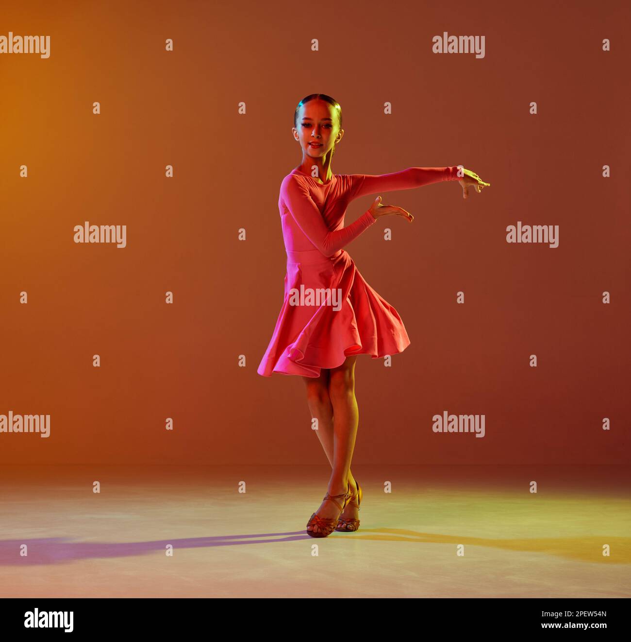 Studio shot of little girl, 11 years old kid in festive stage dress ...