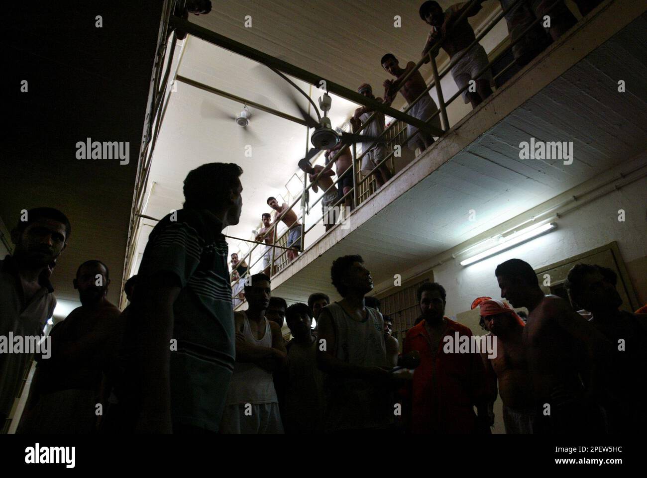 Iraqi inmates walk about freely their cell block during recreation time ...