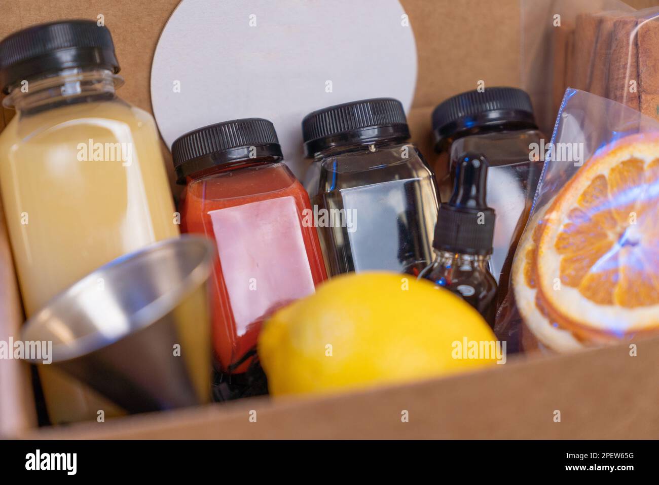 a take-home cocktail making box with various ingredients for creating ...