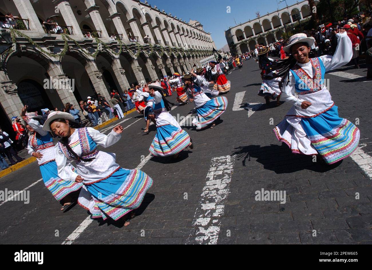 Women dance during a parade to honor the athletes participating in the ...