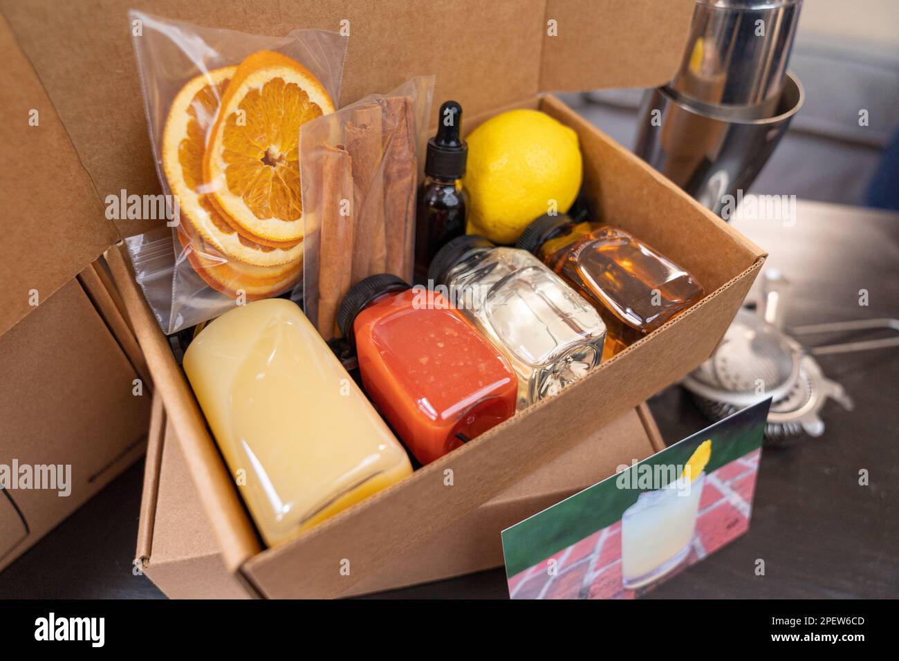 an overhead view of a take-home cocktail making box with various ...