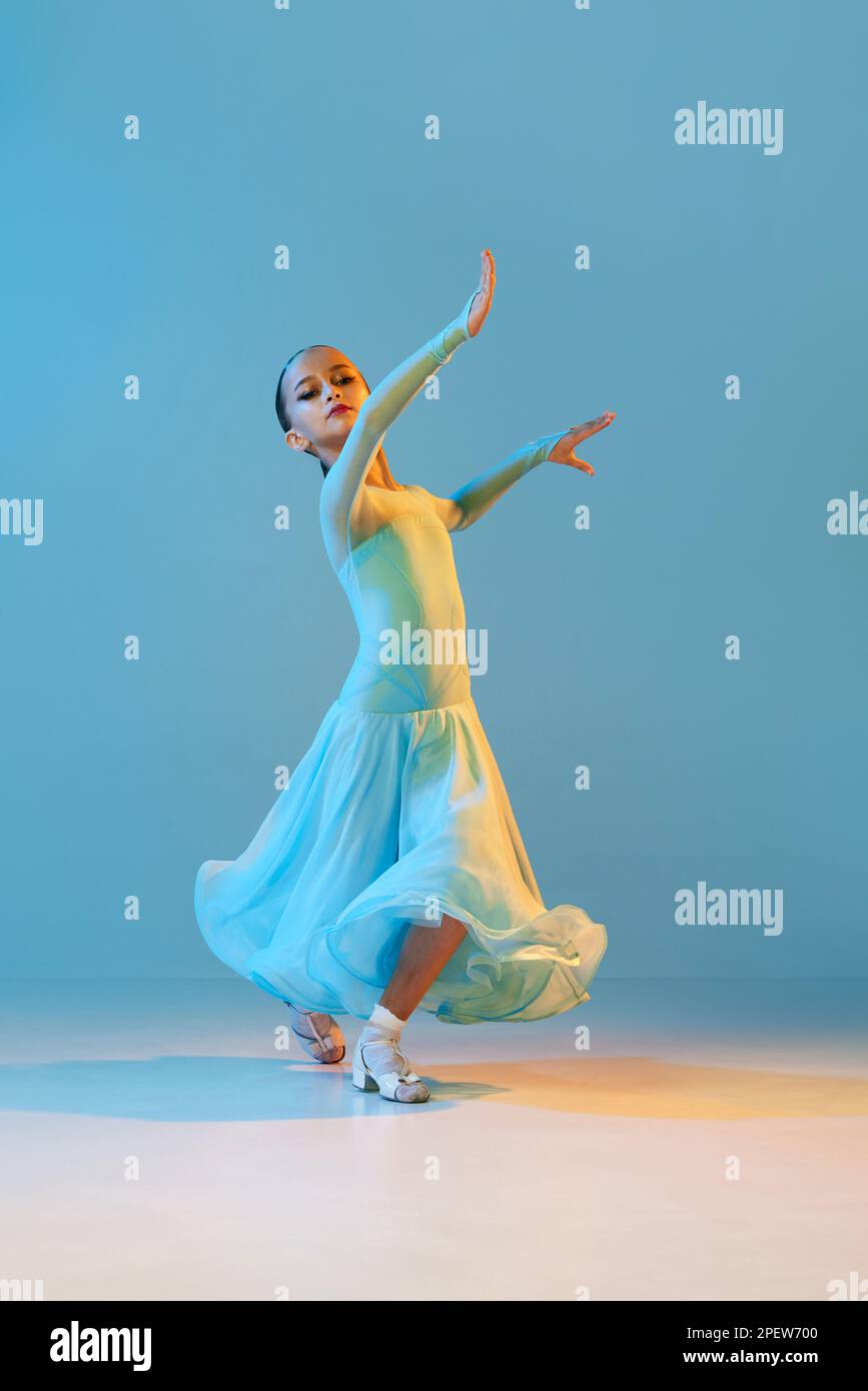 Valse. Portrait of little flexible girl in stage outfit, dress dancing ...