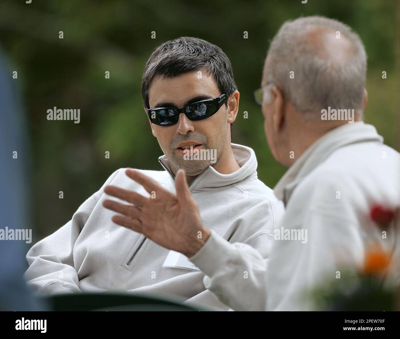 Google's Larry Page, rear, talks with The News Corporation's Rupert ...