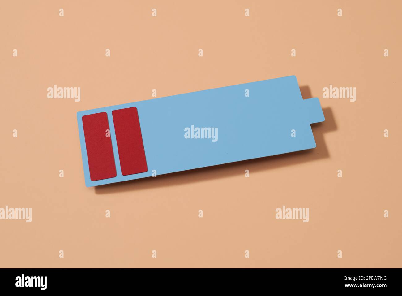 a cardboard depiction of a low battery on a pale pink background Stock ...