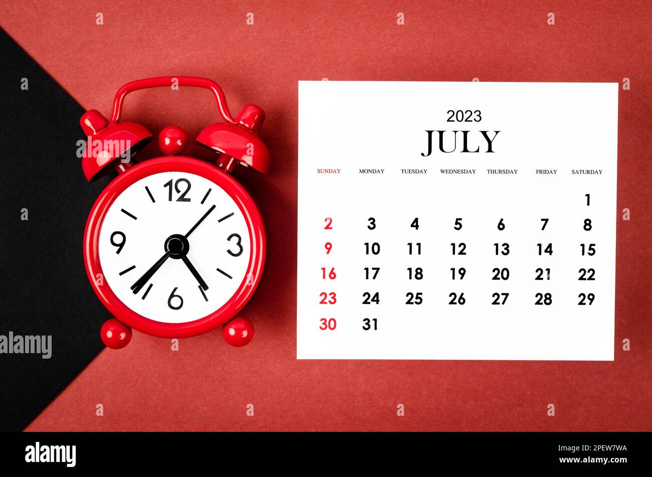 July 2023 Monthly calendar year with alarm clock on red and black ...