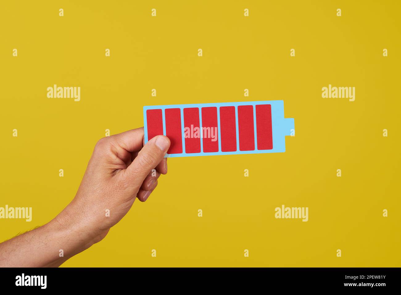 a man is holding a cardboard depiction of a fully charged battery ...