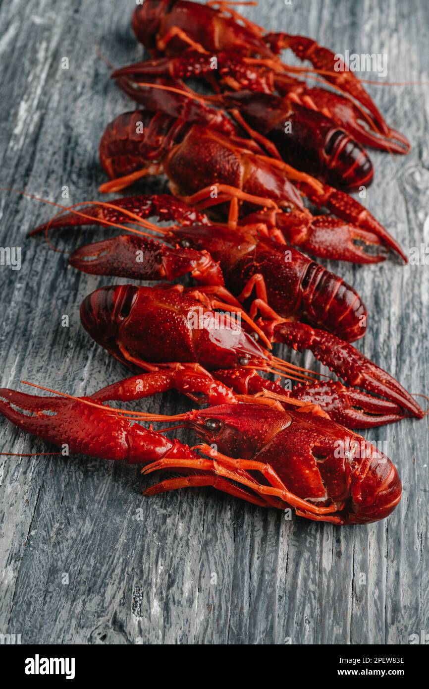 some cooked crayfish forming a line on a gray rustic wooden table Stock ...