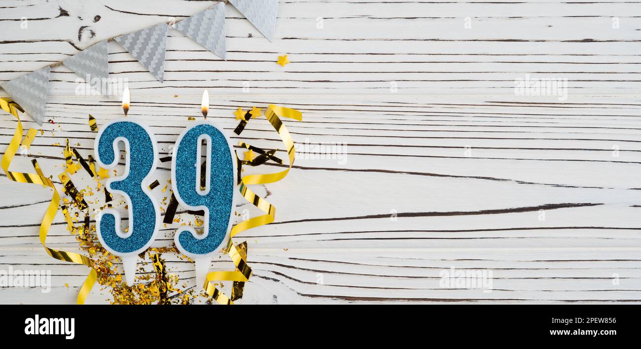 Number 39 blue celebration candle on white wooden background. Happy ...