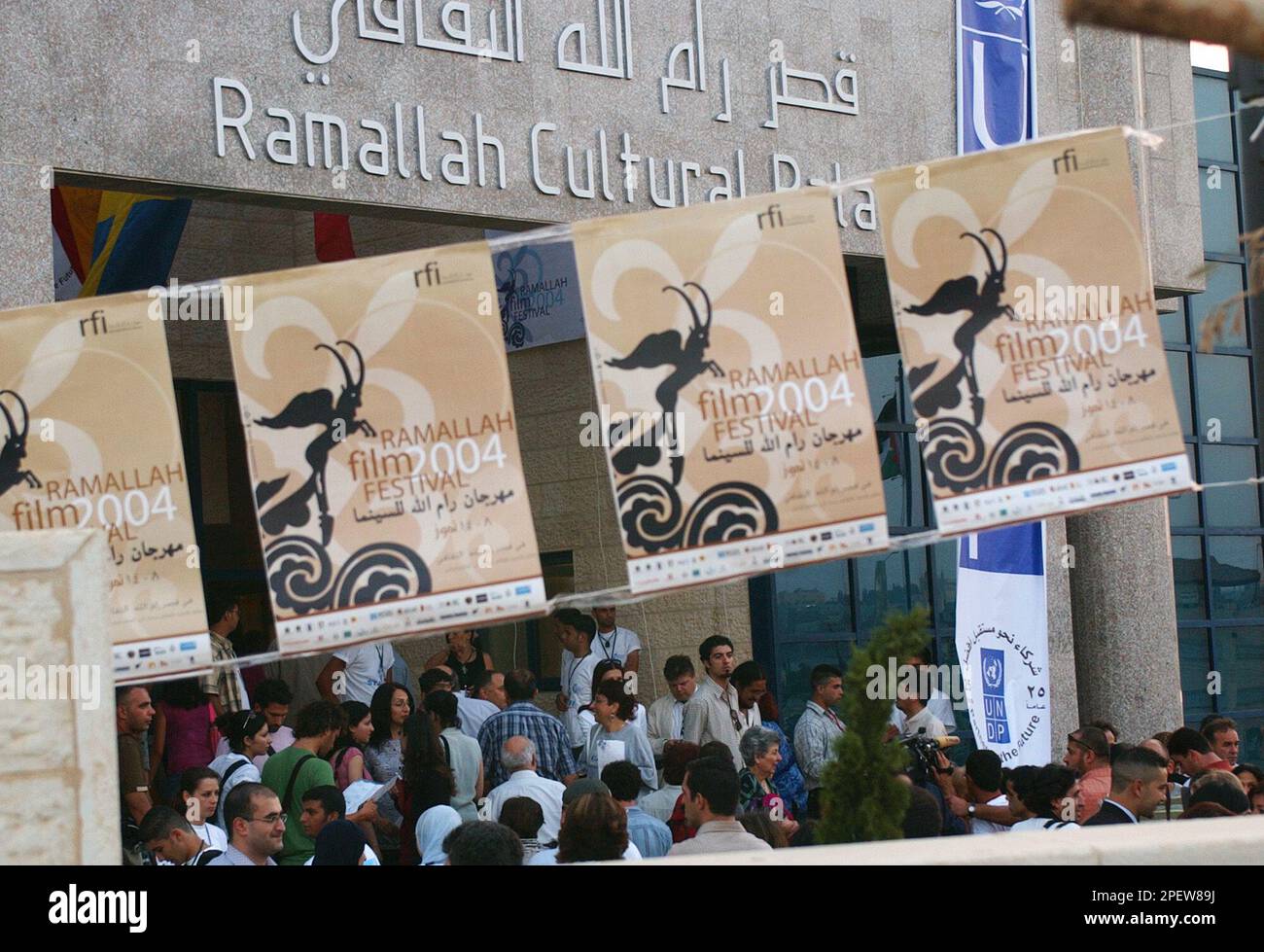 Palestinians gather in front of the Ramallah Cultural Palace to attend ...