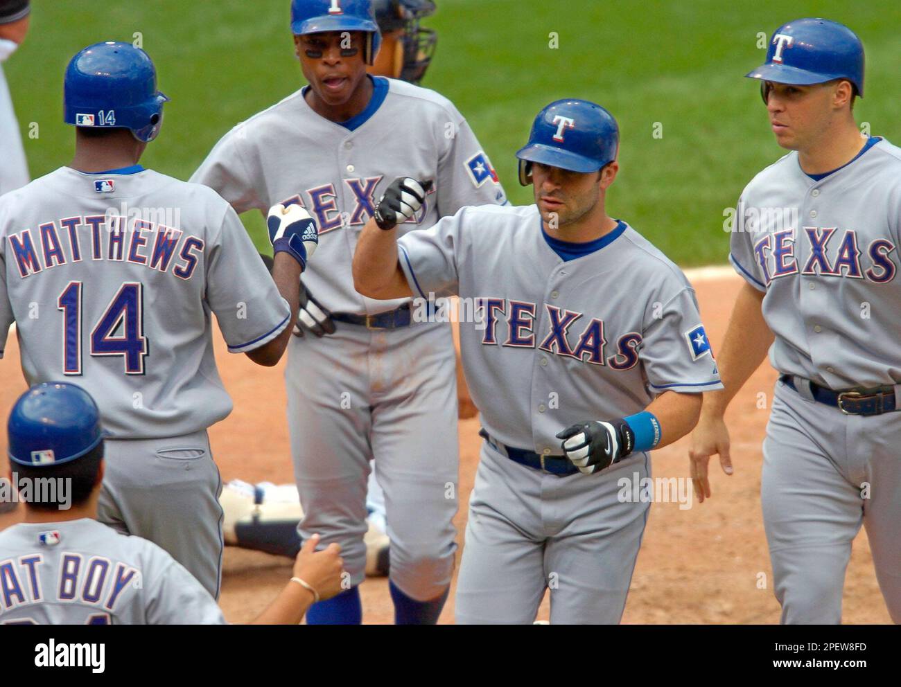 Texas Rangers' David Delucci, second from right, is welcomed at the ...