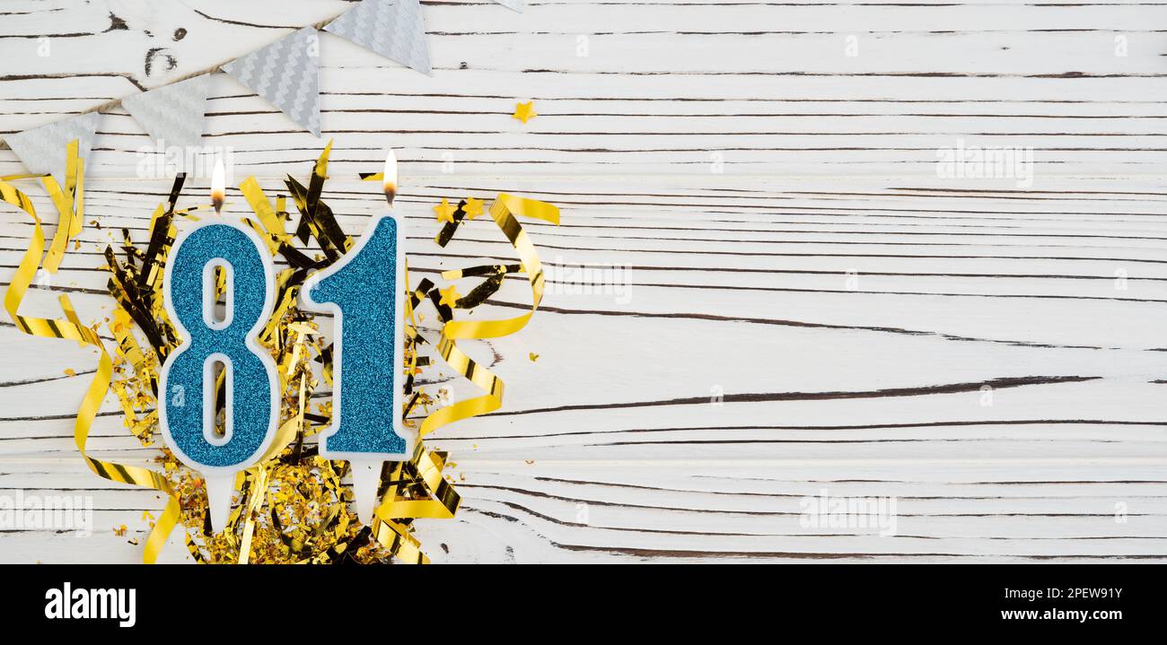 Number 81 blue celebration candle on white wooden background. Happy ...