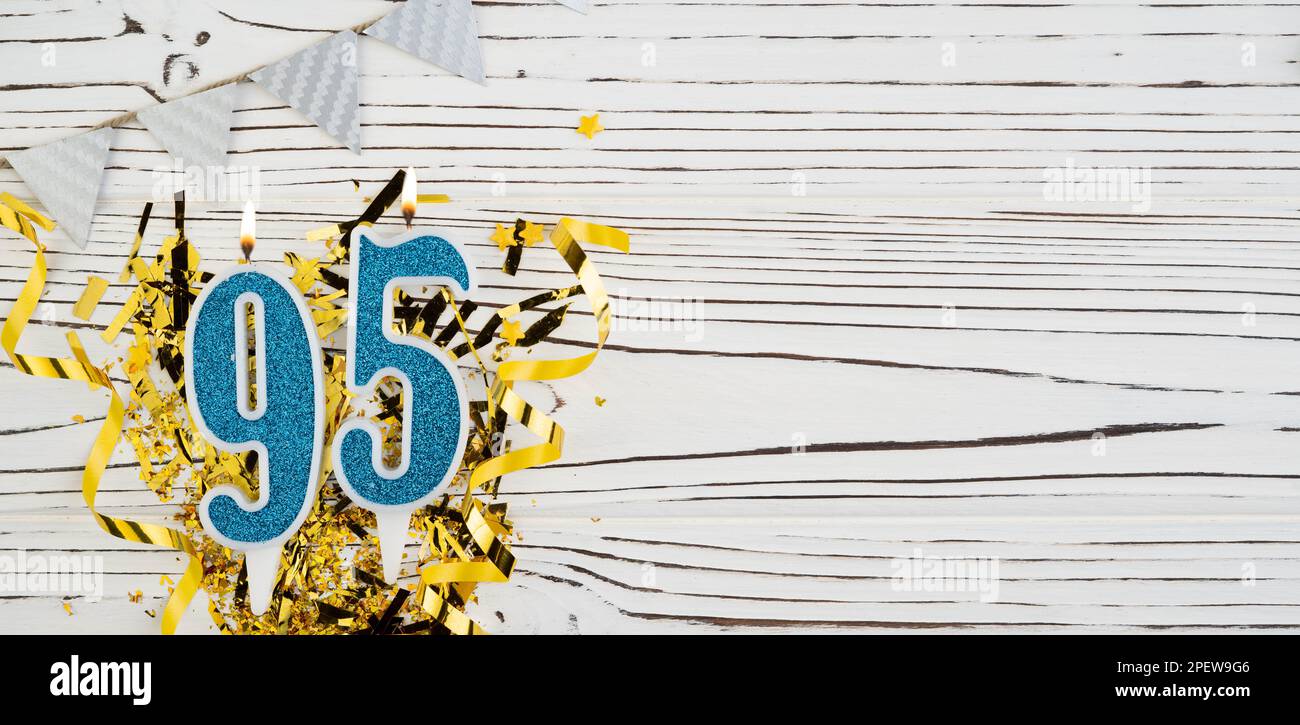 Number 95 blue celebration candle on white wooden background. Happy ...