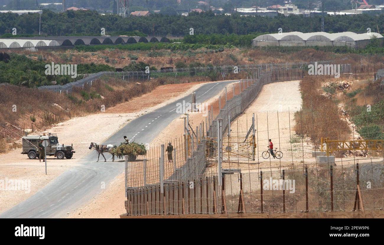 **ONE OF ELEVEN PHOTOS** Palestinians pass through a gate, part of ...