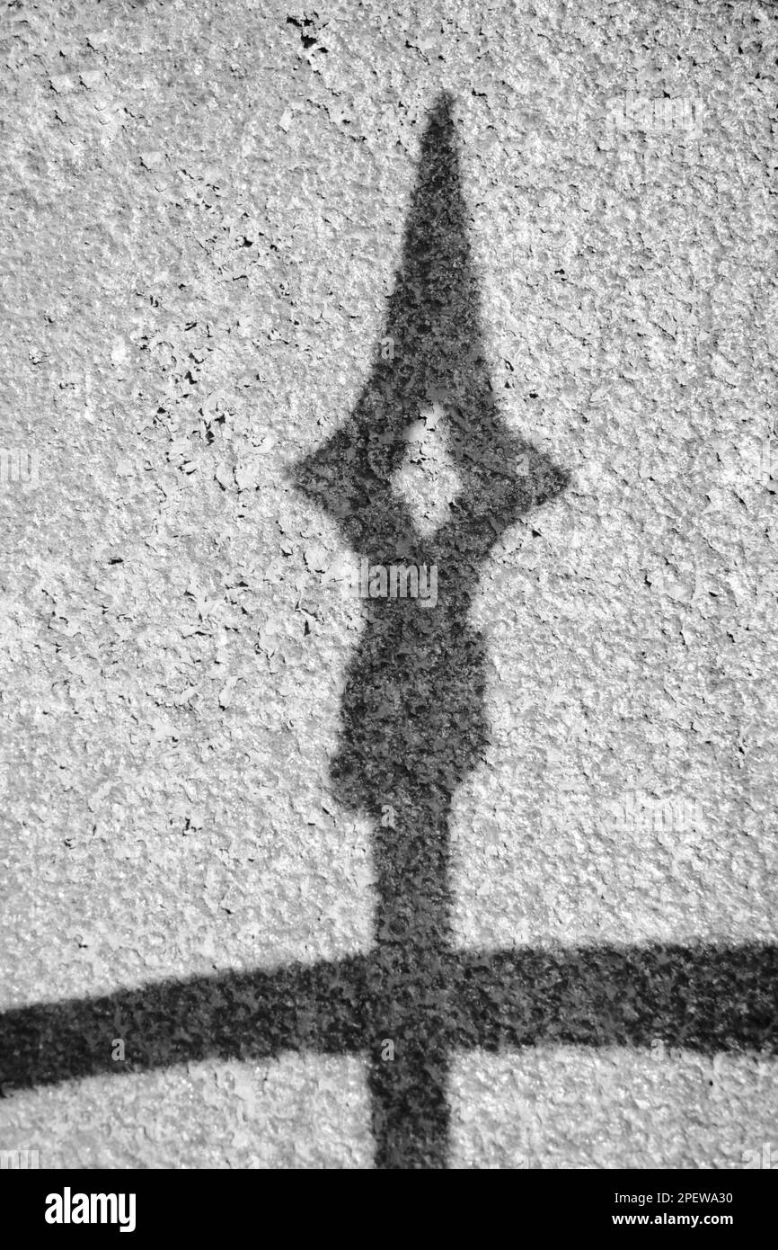 Shadows of the finer details of a medieval fence falling on a vintage ...