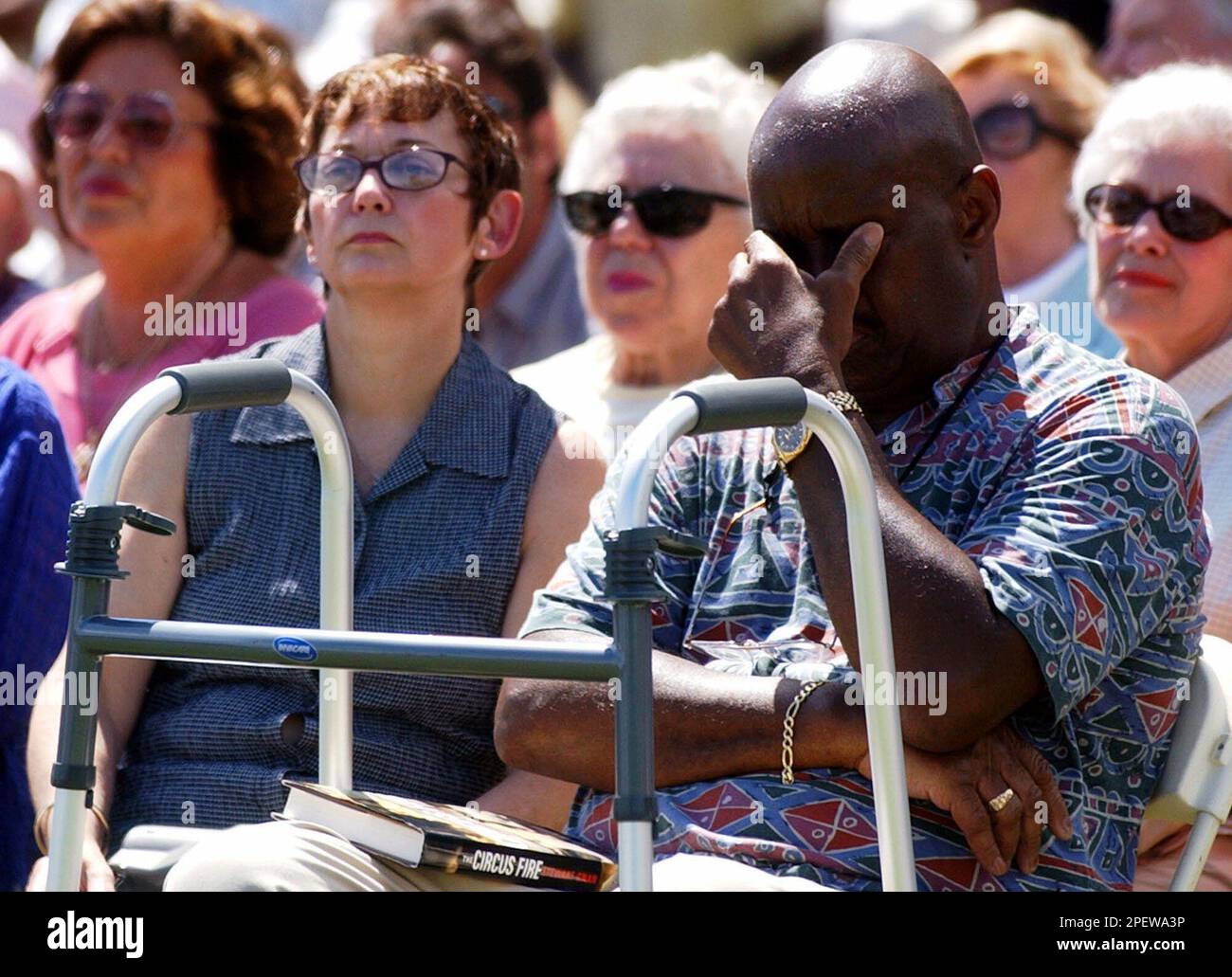 Survivor Billy Epps, right, reacts as he listens to speakers during the ...