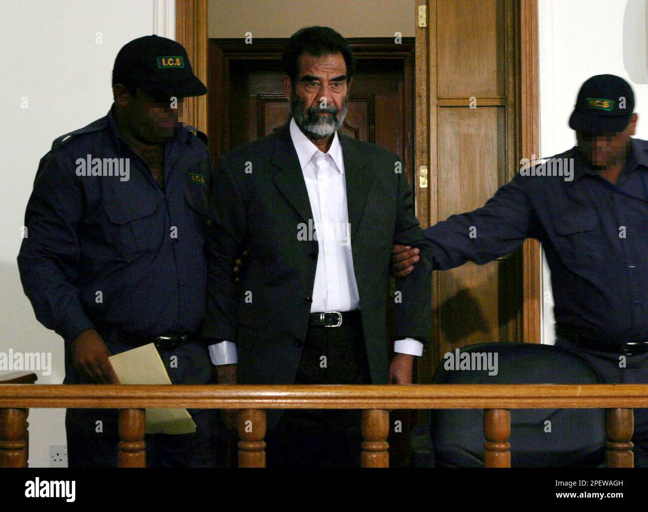 Saddam Hussein is lead into a courtroom Thursday, July 1, 2004 at Camp ...