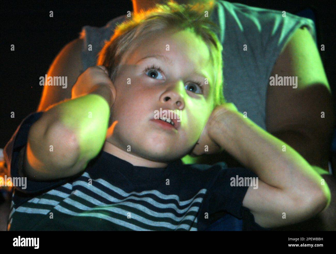 Adam Gaver, 7, covers his ears during the 4th of July fireworks display ...
