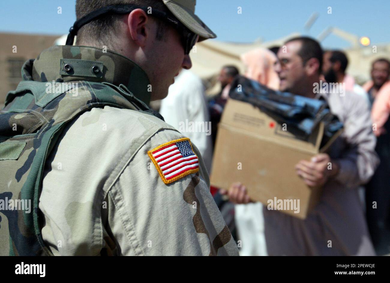 An American military policeman supervises as Iraqi detainees inside the ...